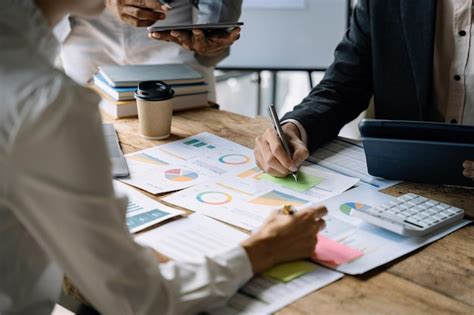 Premium Photo Businessmen Team Or Financial Data Analysts Working With Tablets And Laptop