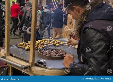 Hands Of Street Vendor Chestnuts Roasted Chestnuts In Street Vendors