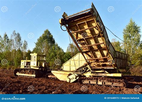 Peat Harvester Tractor On Collecting Extracting Peat Mining And Harvesting Peatland Area