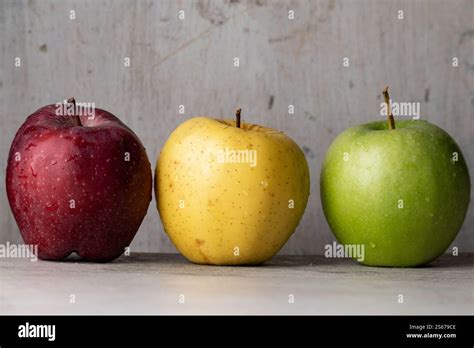 Three Apples Of Different Varieties And Colors Red Yellow Green