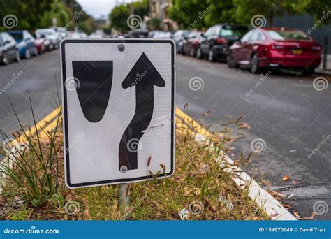 Traffic Sign Directing Cars To Go To Right Of Median Along Crowded