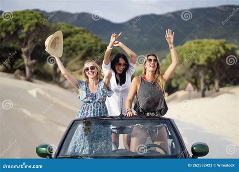 Young Spanish Girls Having Fun While Standing In A Cabriolet Car On A