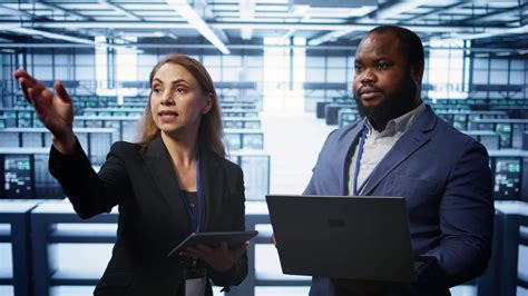 Teamworking Colleagues Doing Checkup Inputting Data On Laptop Of Needed Server Hub Fixes
