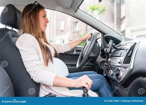 Woman Driving Car. Beautiful Smiling Pregnant Woman Driving Car. Safety Pregnancy Young Mother ...