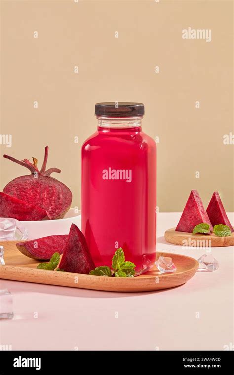 Fresh Beetroot Slices Decorated With Glass Bottle Unlabeled Containing Beetroot Juice On Wooden