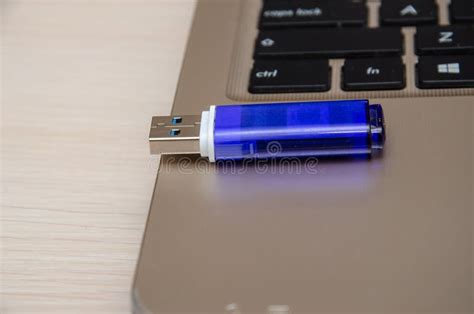 Blue Usb Flash Drive Or Connected To Laptop Computer S Usb Port Notebook Is On A Light Gray
