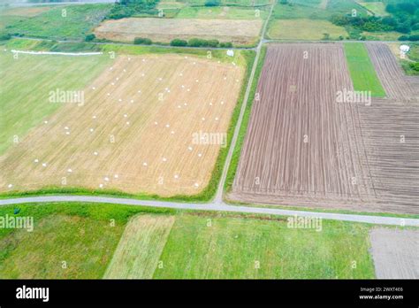 Aerial View Of Agricultural Fields One Field Plowed For Planting And Another Harvested With
