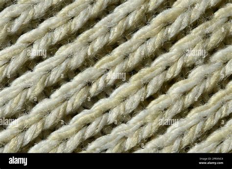 fabric texture of a soft yellow knitted sweater macro image of the