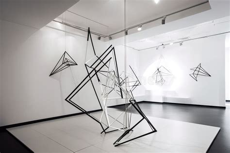 Kinetic And Interactive Geometric Art Installation In Modern Minimalist Room With White Walls