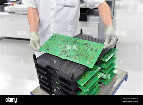 Production And Assembly Of Printed Circuit Boards In An Industrial Factory Workers Check