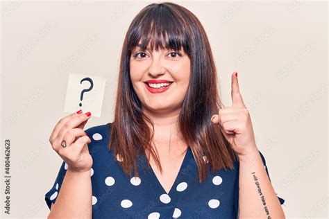 Babe Plus Size Woman Holding Question Mark Smiling With An Idea Or Question Pointing Finger