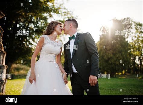 Cute Newly Married Couple Kissing Next To An Old Fountain On Their Wedding Day Stock Photo Alamy