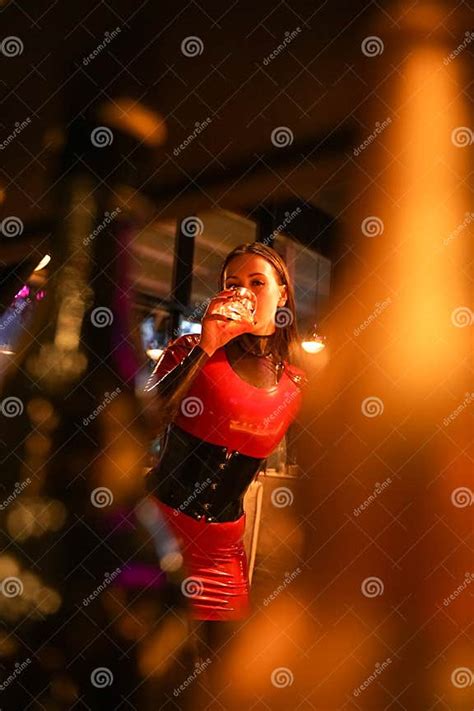 Brave Girl In Latex Walks In Public And Shows Her Exhibitionism Stock