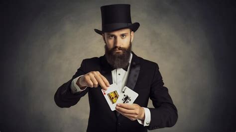 A Bearded Magician In A Black Suit And Top Hat Showing Trick With