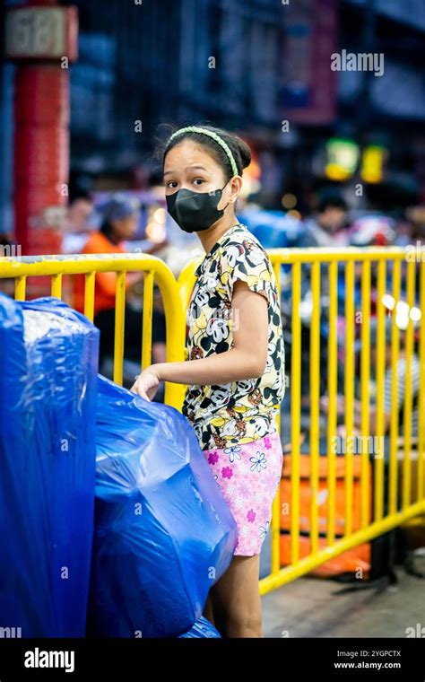 A Young Filipino Girl Works In The Clothing Market In The Binondo China