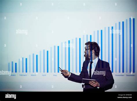 Successful Businessman With Touchpad Presenting Data In Chart Stock