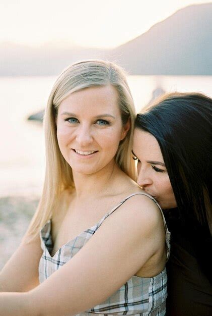 Premium Photo Woman Kisses The Shoulder Of Her Smiling Girlfriend