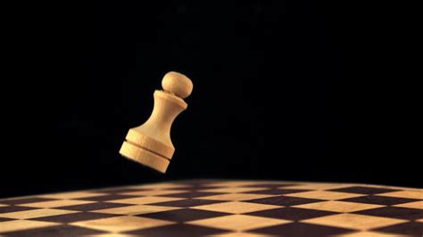 Super Slow Motion Chess Figure Falls On The Chessboard On A Black