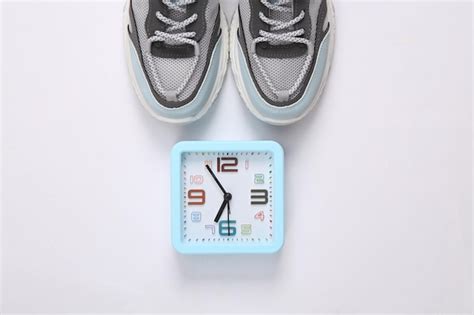 Premium Photo Running Shoes And Alarm Clock On White Background Sport