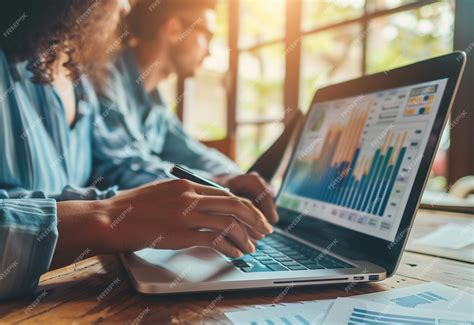 a man is working on a laptop with a graph showing the graph graph premium ai generated image