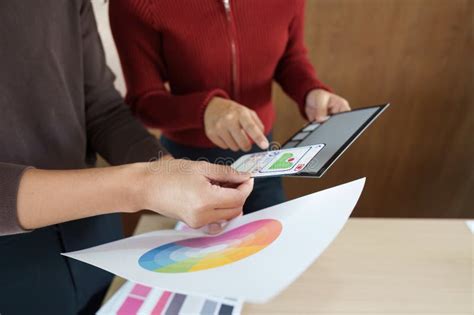 Collaborative Design Review Team Evaluates Color Palette Alongside Mobile Design Mockups Stock