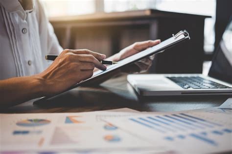 Premium Photo Close Up Of Businesswoman Analyzing Graphs On Table