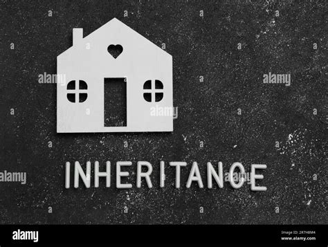 Word Inheritance Made With Letters And House Model On Black Background