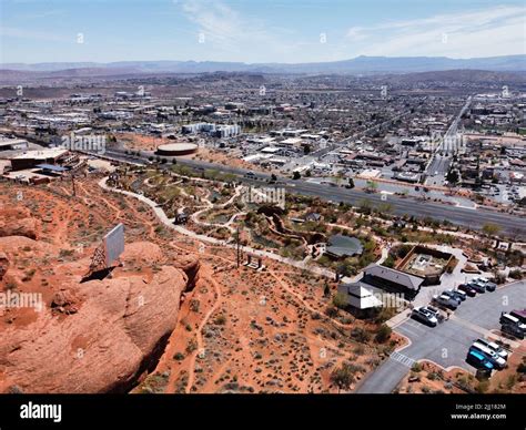 An aerial drone view of the cityscape of Moab with red rock formations ...