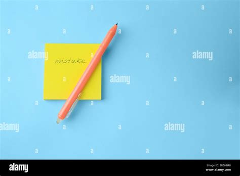 Paper Notes With Word Mistake And Erasable Pen On Light Blue Background