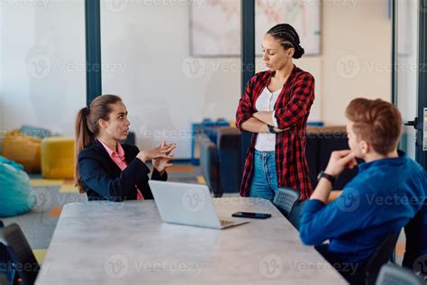 A Team Of Successful Programmers Sits In A Startup Office Strategizing New Business Projects