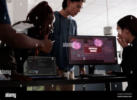 Team Of Software Developers Looking At Monitor Dealing With Security