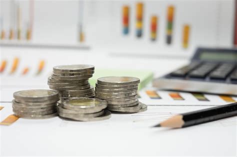 Premium Photo Business Concept With Coins Stack Graph And Calculator