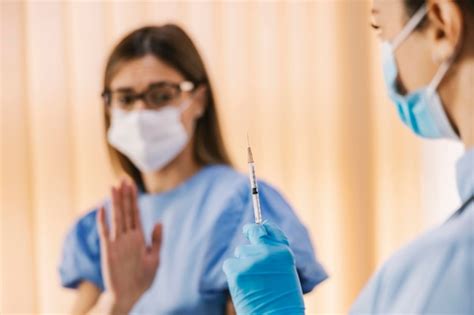 Premium Photo Selective Focus On Syringe With Cure While A Patient Rejecting It