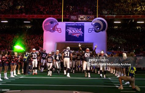 The New England Patriots Run Onto The Field At Super Bowl Xxxvi At