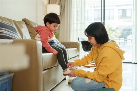Asian Chinese Mother Helping Her Son Put Shoes On Stock Image Image