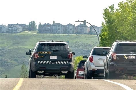 A Calgary Police Vehicle Car Driving On A Neighbourhood During The