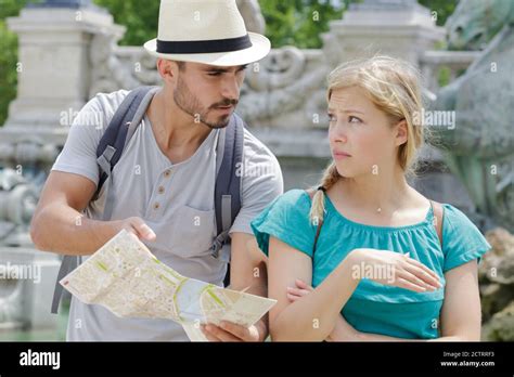 Man With Map Shows Girlfriend The Right Direction Stock Photo Alamy