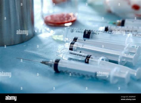 Many Syringes On A Blue Sheet In Operation Room Different Sizes Of