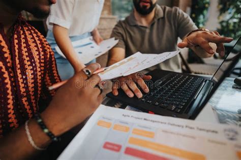 Businesspeople Collaborating On Project Management Plan With Charts And