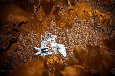 Wedding Couple Lying Under A Tree Stock Photo At Vecteezy