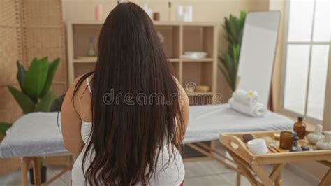 Curvy Woman With Long Hair Sitting In A Wellness Spa Room With A