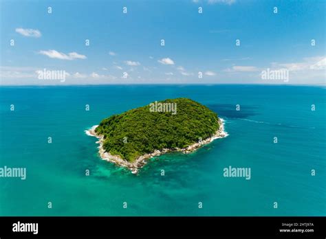 Aerial View Landscape Of Small Island In Tropical Sea Against Blue Sky