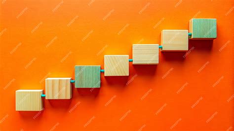 Wooden Blocks Forming A Timeline With Milestones On A Bright Orange Background Premium Ai