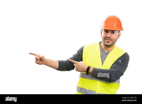 Cheerful Male Constructor Smiling Pointing At Blank Copyspace For