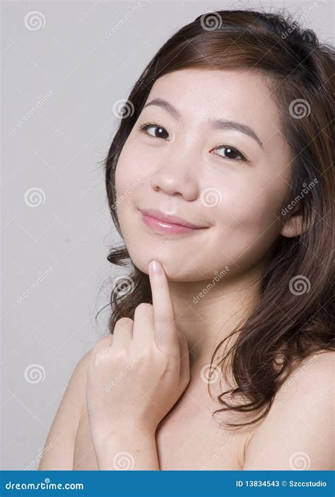 Smiling Asian Girl With A Finger Touching Her Chin Stock Image Image