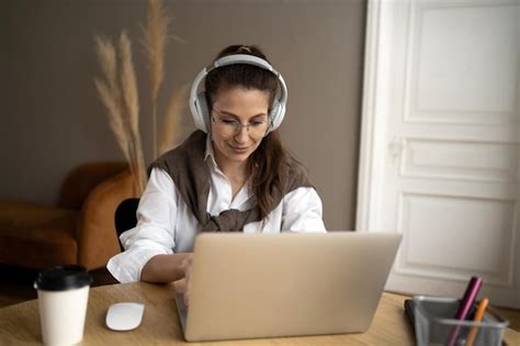 Premium Photo A Woman With Headphones A Programmer With Glasses In
