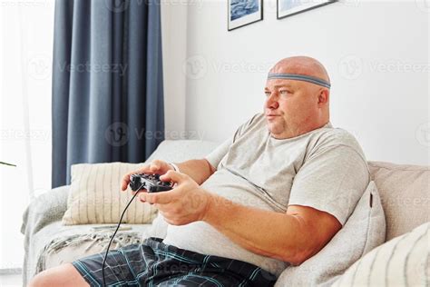 Plays Video Game Funny Overweight Man In Casual Clothes Is Indoors At