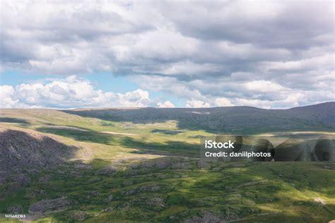 변화하는 날씨에 구름의 햇빛과 그림자가있는 녹색 산맥이있는 미니멀리스트 풍경 햇볕이 잘 드는 산과 흐린 하늘이있는 최소한의 자연 배경 간단한 산 미니멀리즘 0명에 대한 스톡