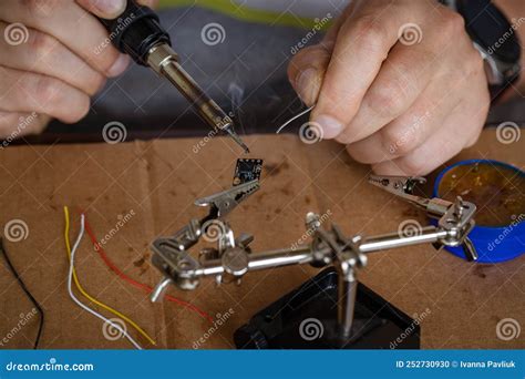 The Hand Holding The Tin A Soldering Iron Solder The Chip In Place A