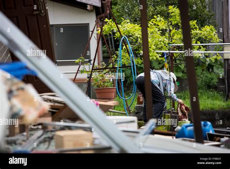 Kumamoto Japan April 22 An Earthquake Survivor Is Seen Through The Wreckage Of Houses On